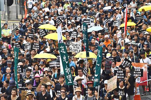 HK advocates march on Chinese national day - Taipei Times
