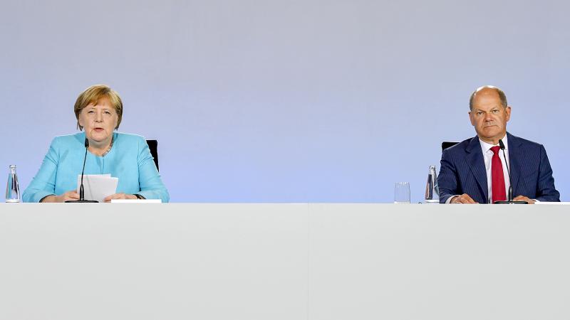 Merkel seals US$146bn aid deal - Taipei Times